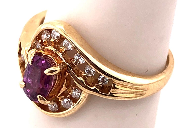 14 Karat Yellow Gold Purple Peridot Ring with Round Diamond Accents 0. ...