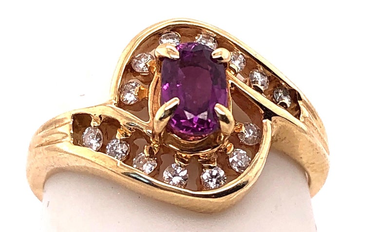 14 Karat Yellow Gold Purple Peridot Ring with Round Diamond Accents 0. ...
