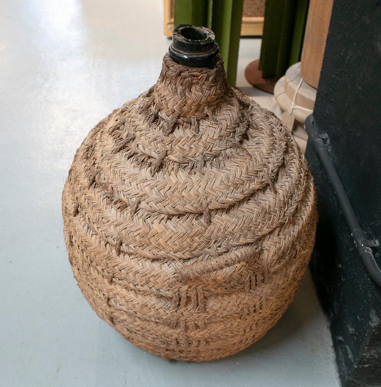1950s Spanish Glass Demijohn in Hand Woven Esparto Grass Basket at 1stDibs