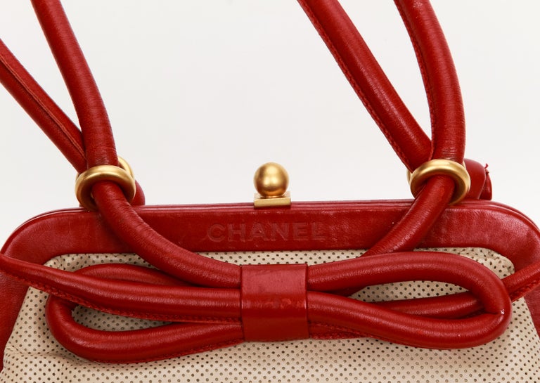 1990's Vintage Chanel Beige and Red Perforated Bow Bag at 1stDibs