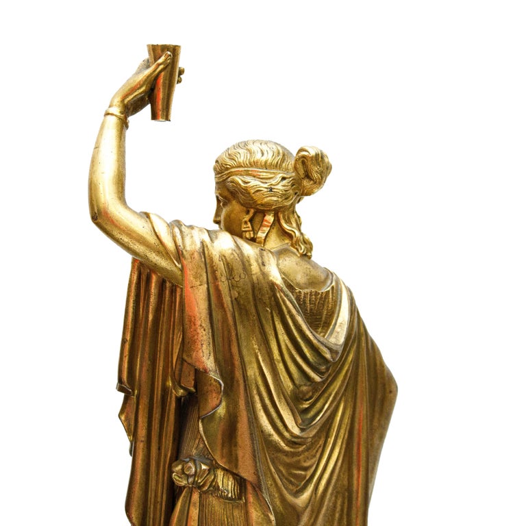 19th century, Pair of classic torch-holding figures in gilded bronze ...