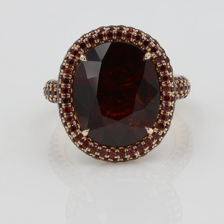 9.13 Carat Oval Cut Garnet with Small Round Cut Garnets in 18 Karat Gold Ring For Sale at 1stDibs