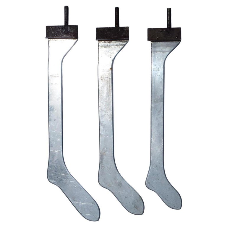 A collection of three different sized metal industrial sock or stocking ...