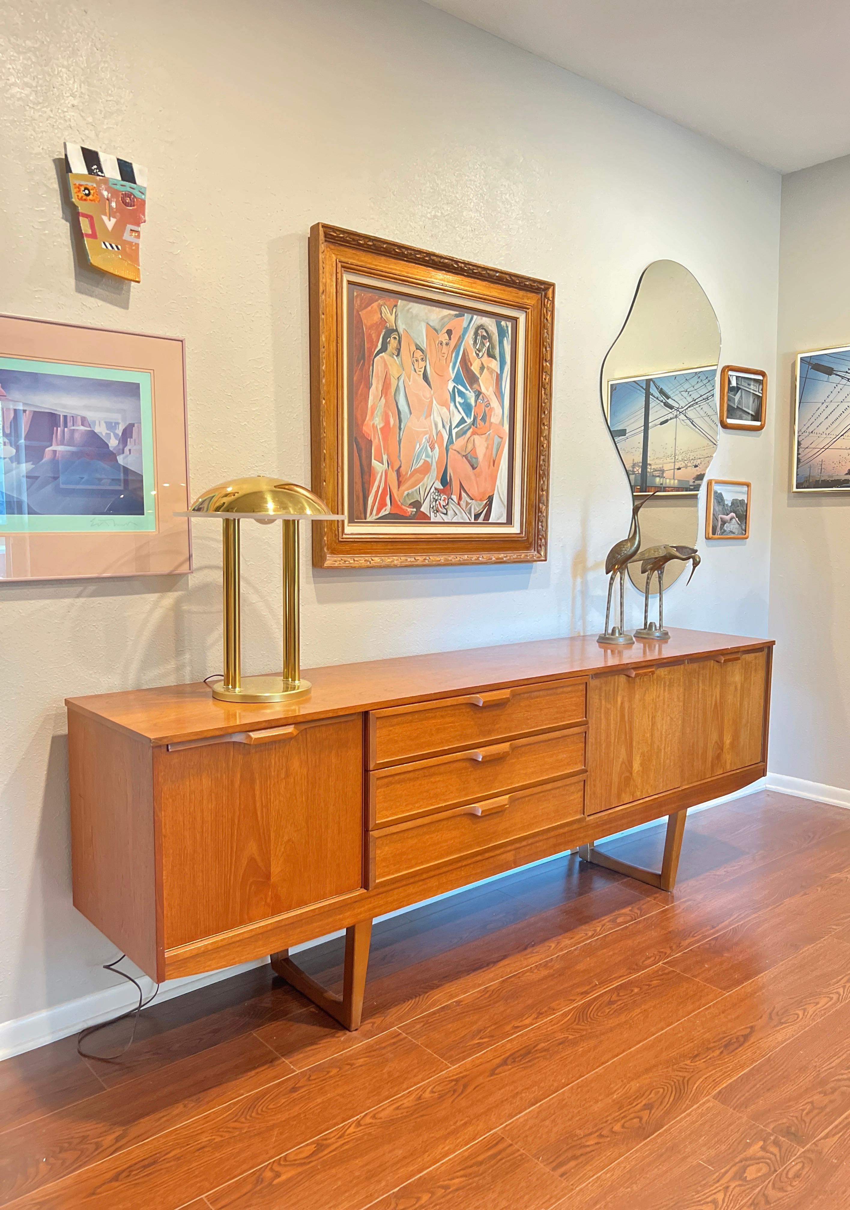 A large 80” mid century modern teak sideboard featuring sleigh legs For ...