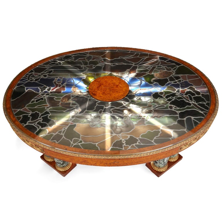 A large amboyna, stained glass, marble, and ormolu mounted centre table ...
