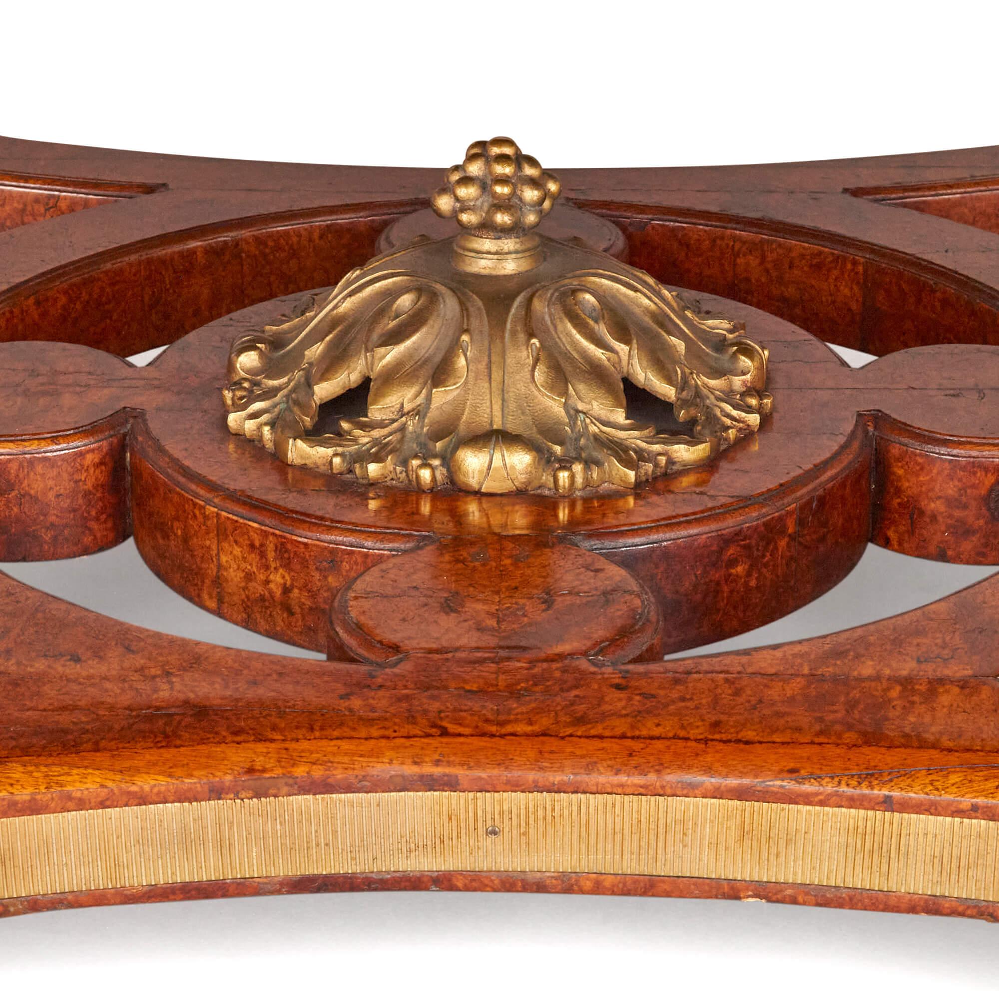 A large amboyna, stained glass, marble, and ormolu mounted centre table ...