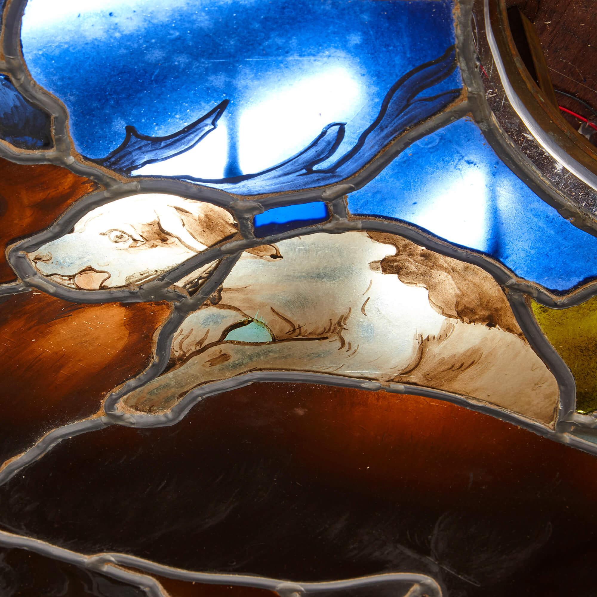 A large amboyna, stained glass, marble, and ormolu mounted centre table ...