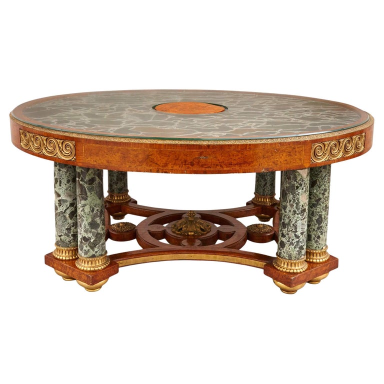 A large amboyna, stained glass, marble, and ormolu mounted centre table ...