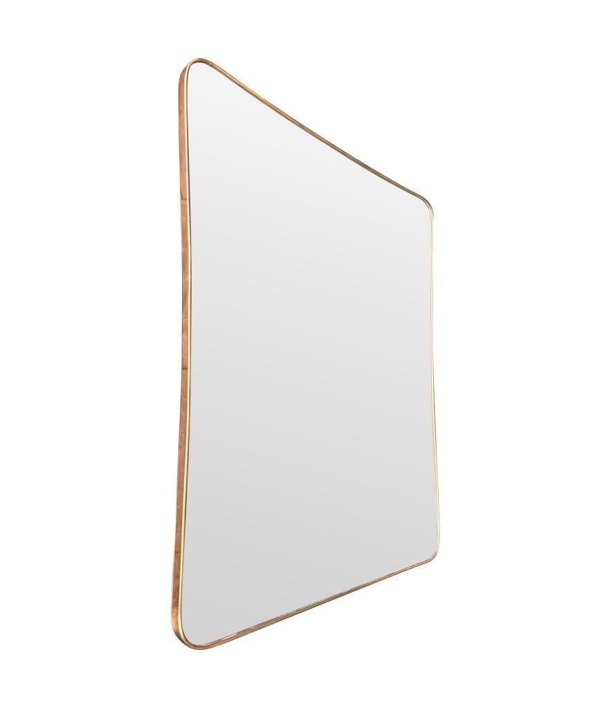 A large orignal 1950s Italian brass framed mirror with wide proportions ...