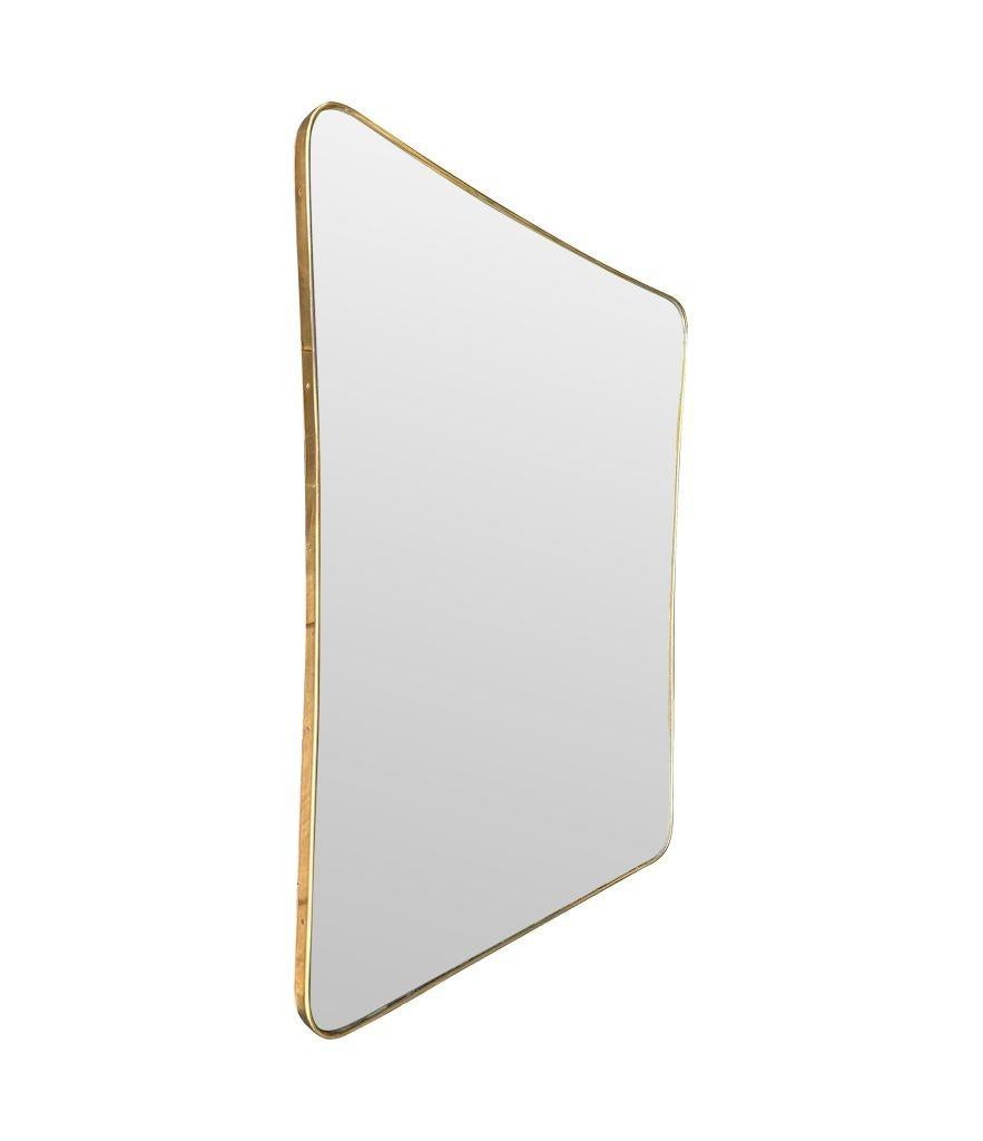 A large orignal 1950s Italian brass framed mirror with wide proportions ...