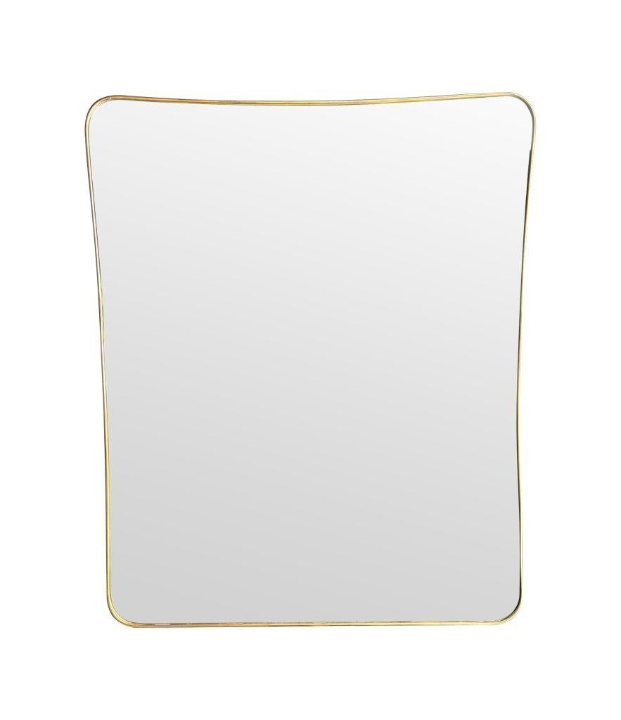 A large orignal 1950s Italian brass framed mirror with wide proportions ...