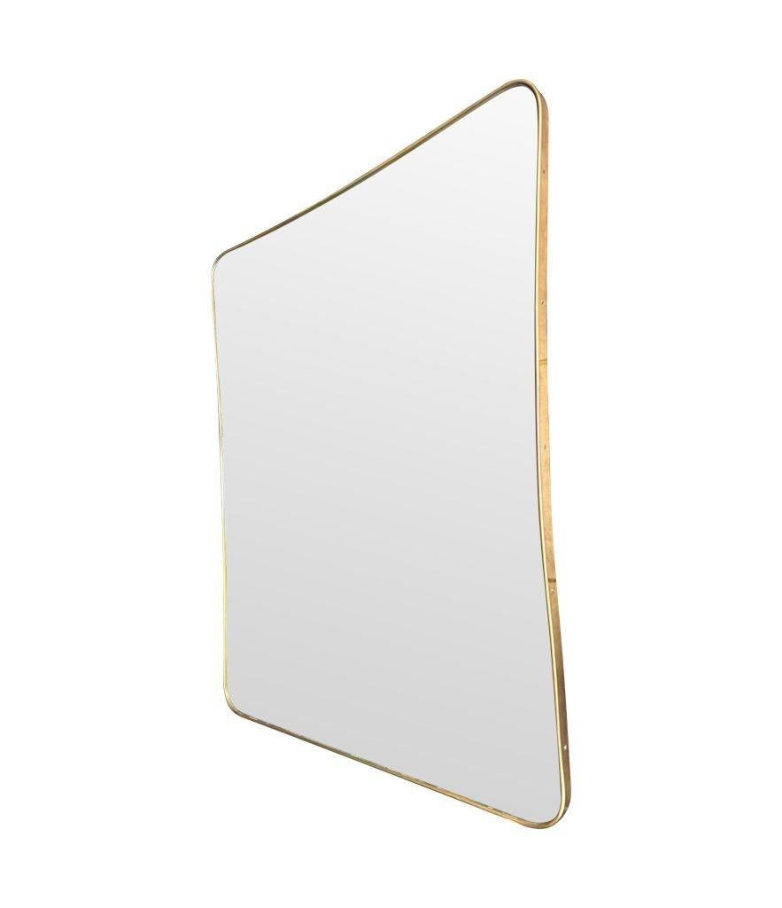 A large orignal 1950s Italian brass framed mirror with wide proportions ...