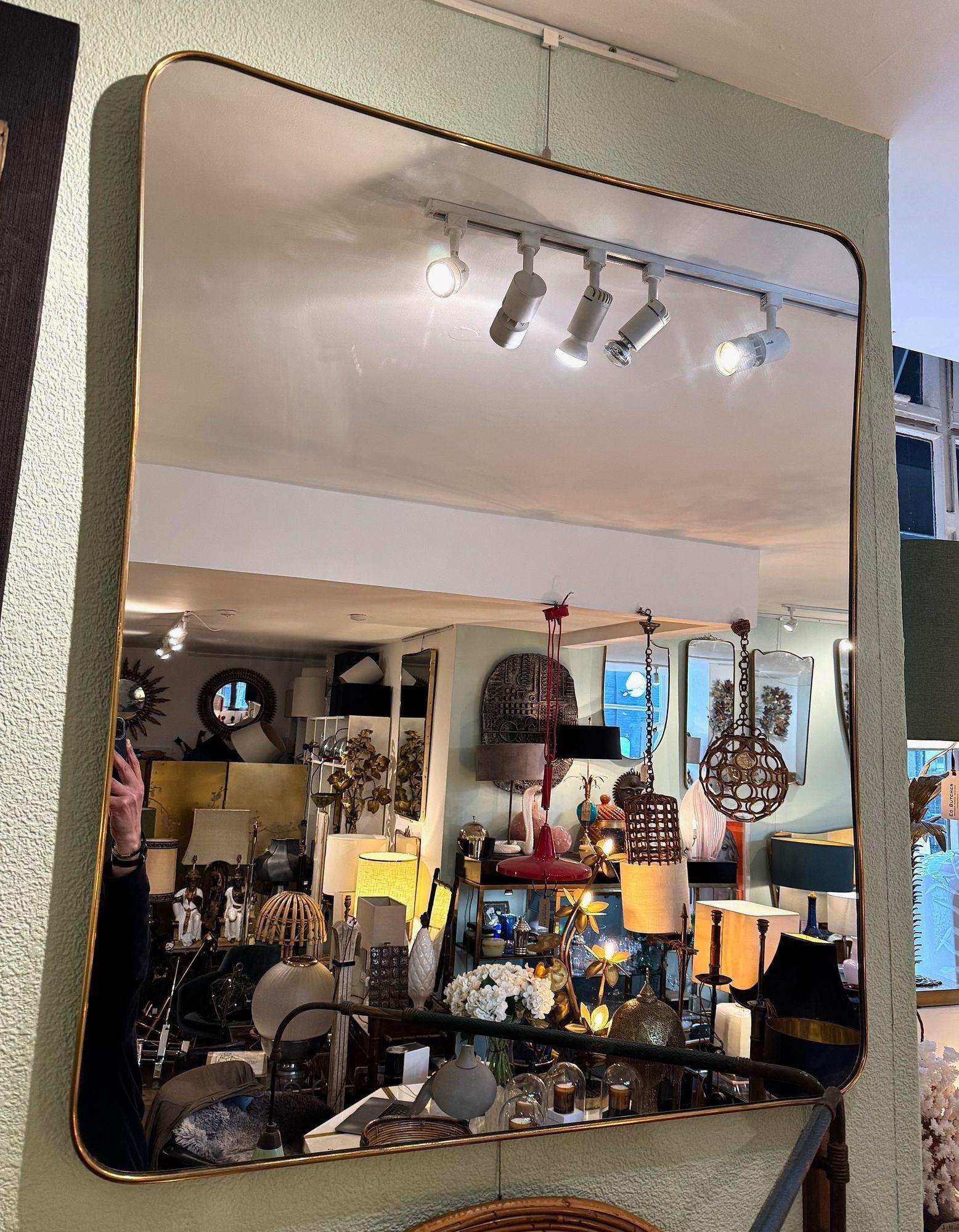 A large orignal 1950s Italian brass framed mirror with wide proportions ...