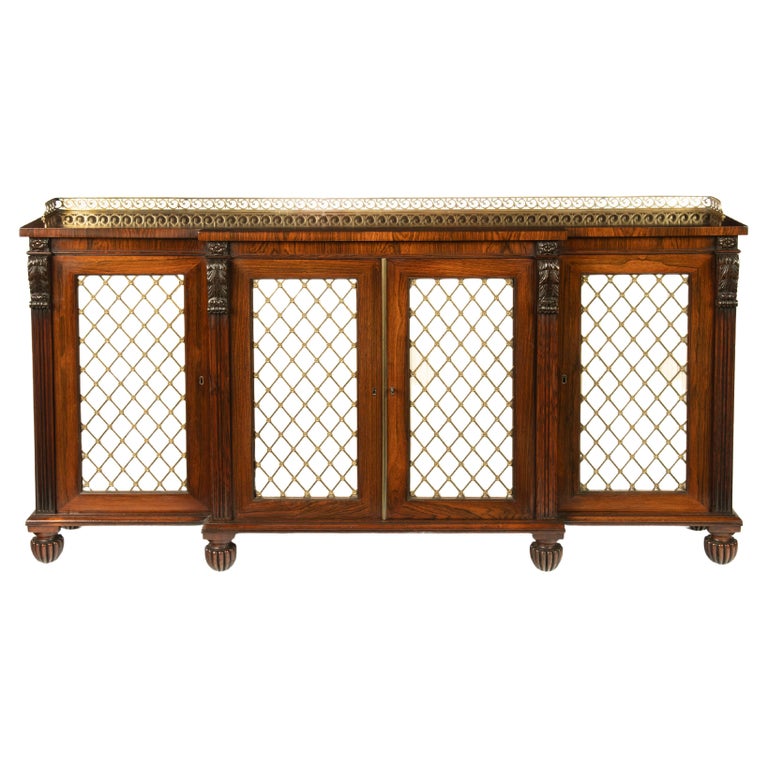 A late Regency rosewood breakfront four door side cabinet, attributed ...