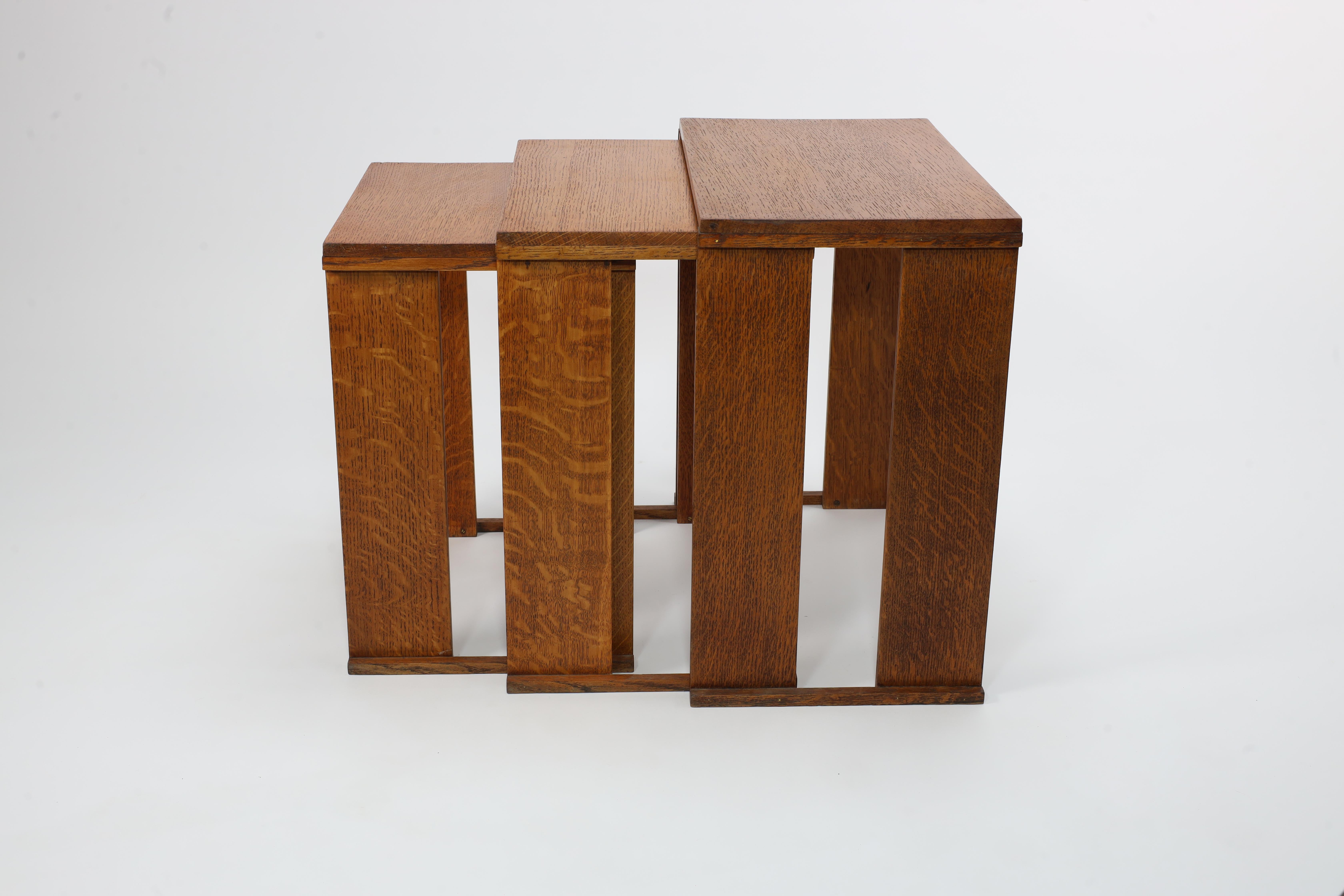 A nest of three Art Deco wild grain oak side tables of planked ...