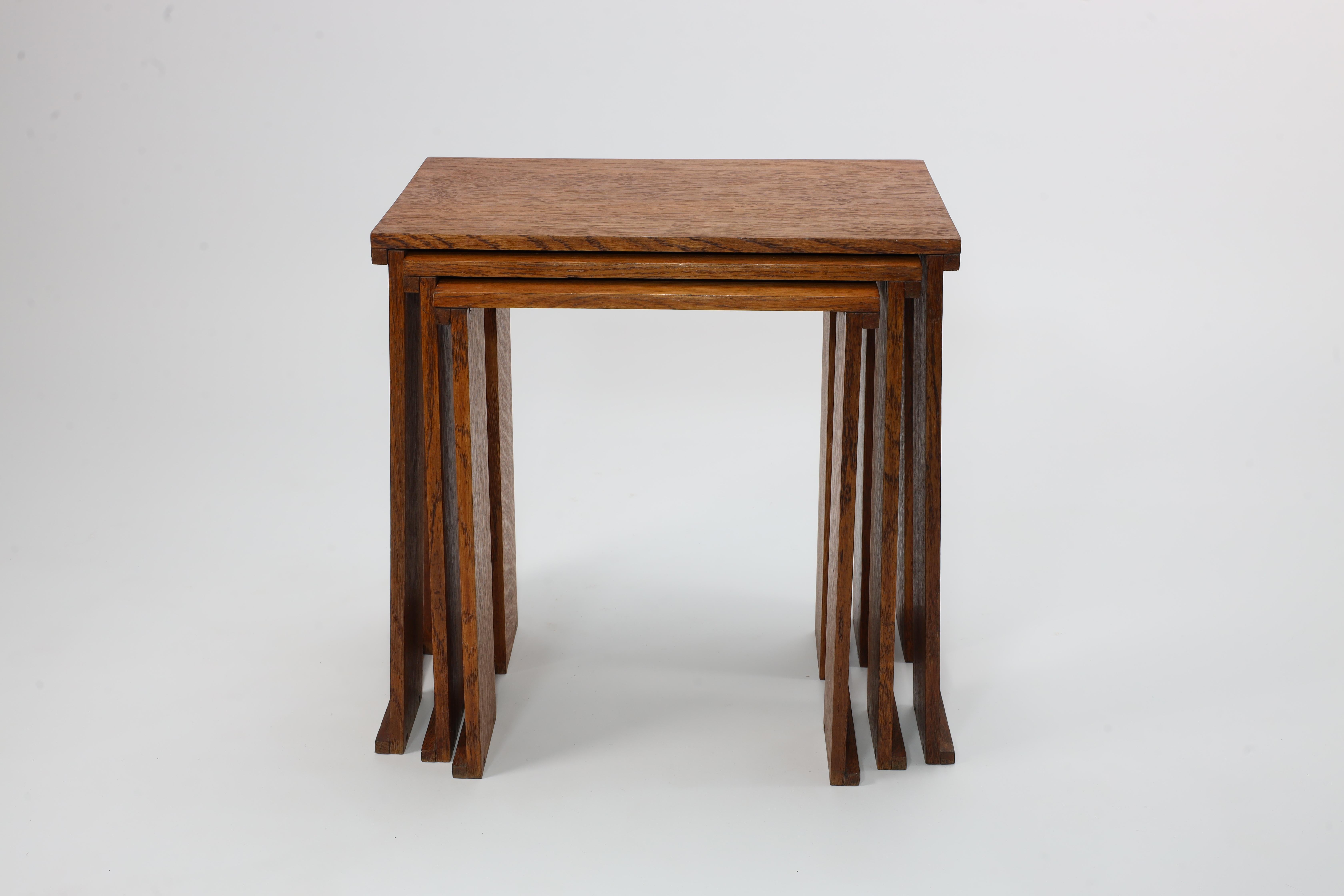 A nest of three Art Deco wild grain oak side tables of planked ...