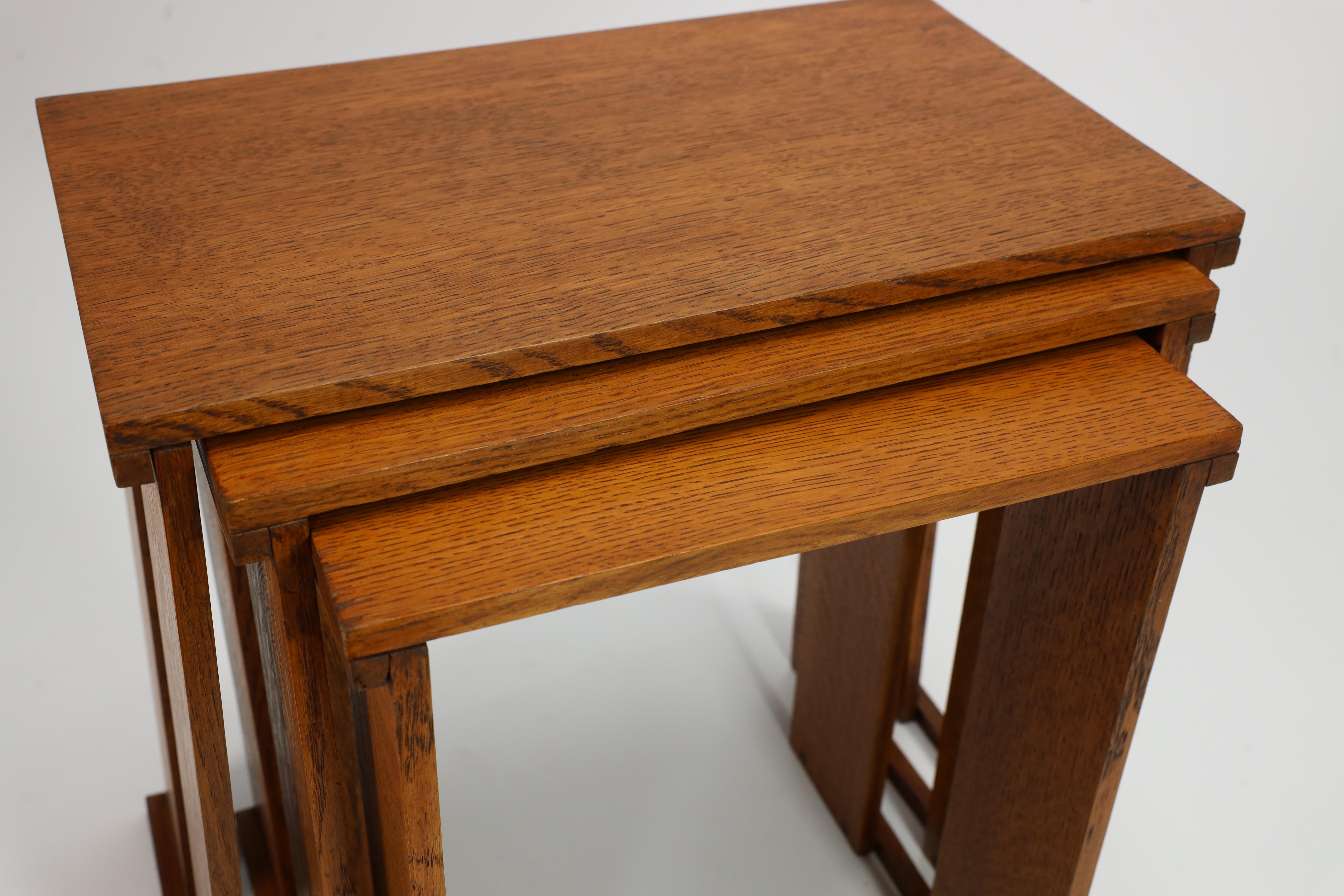 A nest of three Art Deco wild grain oak side tables of planked ...