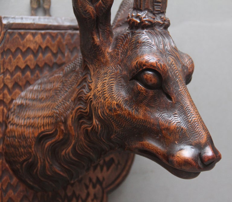 A pair of decorative 19th Century carved walnut black forest deer heads ...