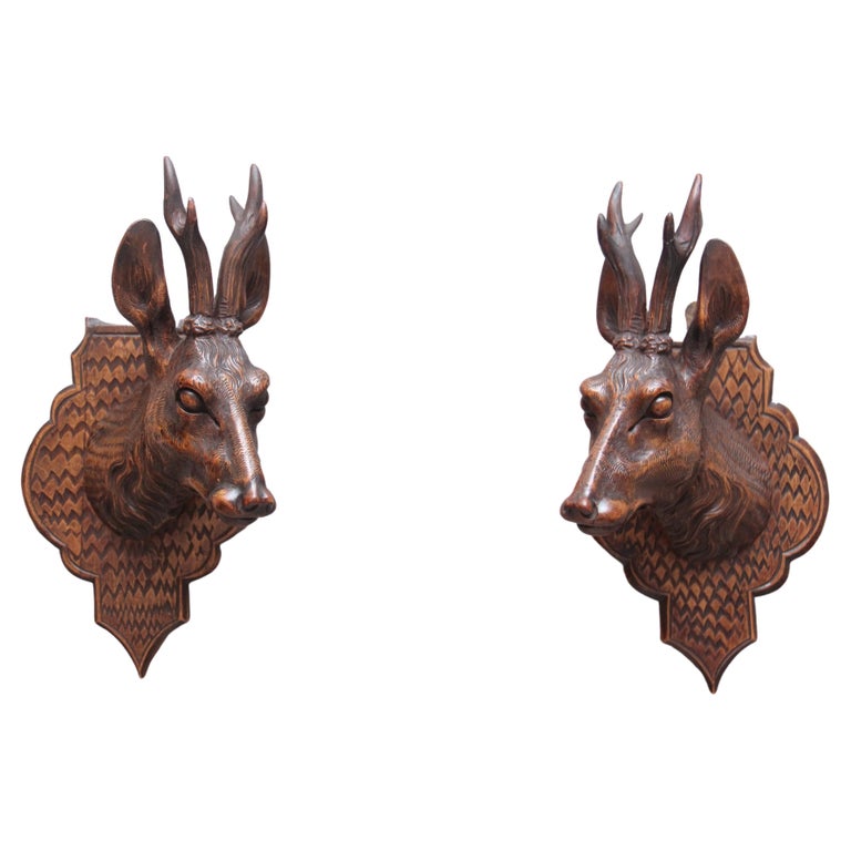 A pair of decorative 19th Century carved walnut black forest deer heads ...