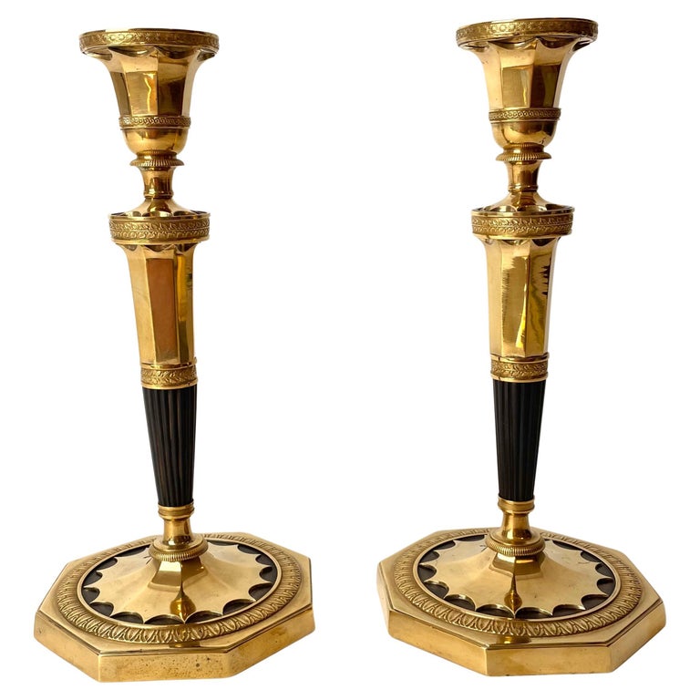 A pair of elegant gilded and dark patinated Empire Candlesticks, circa ...