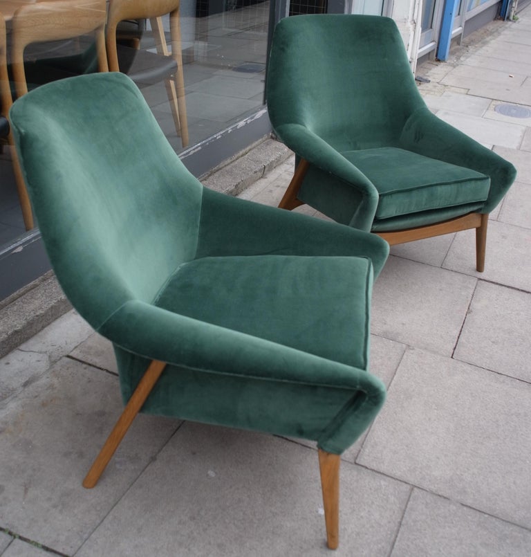 A pair of vintage 1950s British manufactured armchair covered in green ...