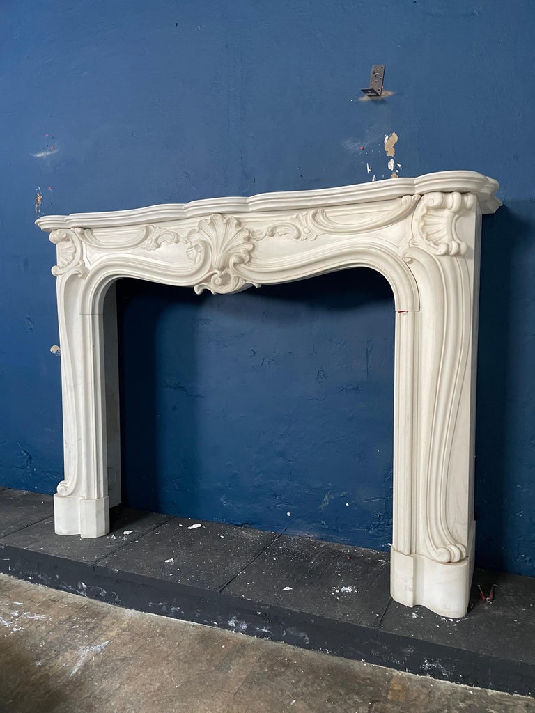 A Reclaimed Rococo French Style Marble Fireplace Mantel For Sale at 1stDibs