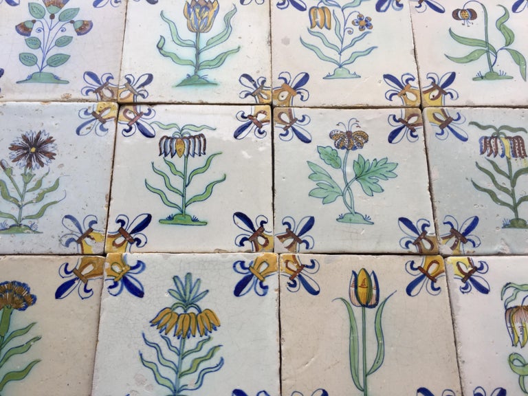 A set of 12 polychrome Dutch Delft tiles with flowers For Sale at 1stDibs