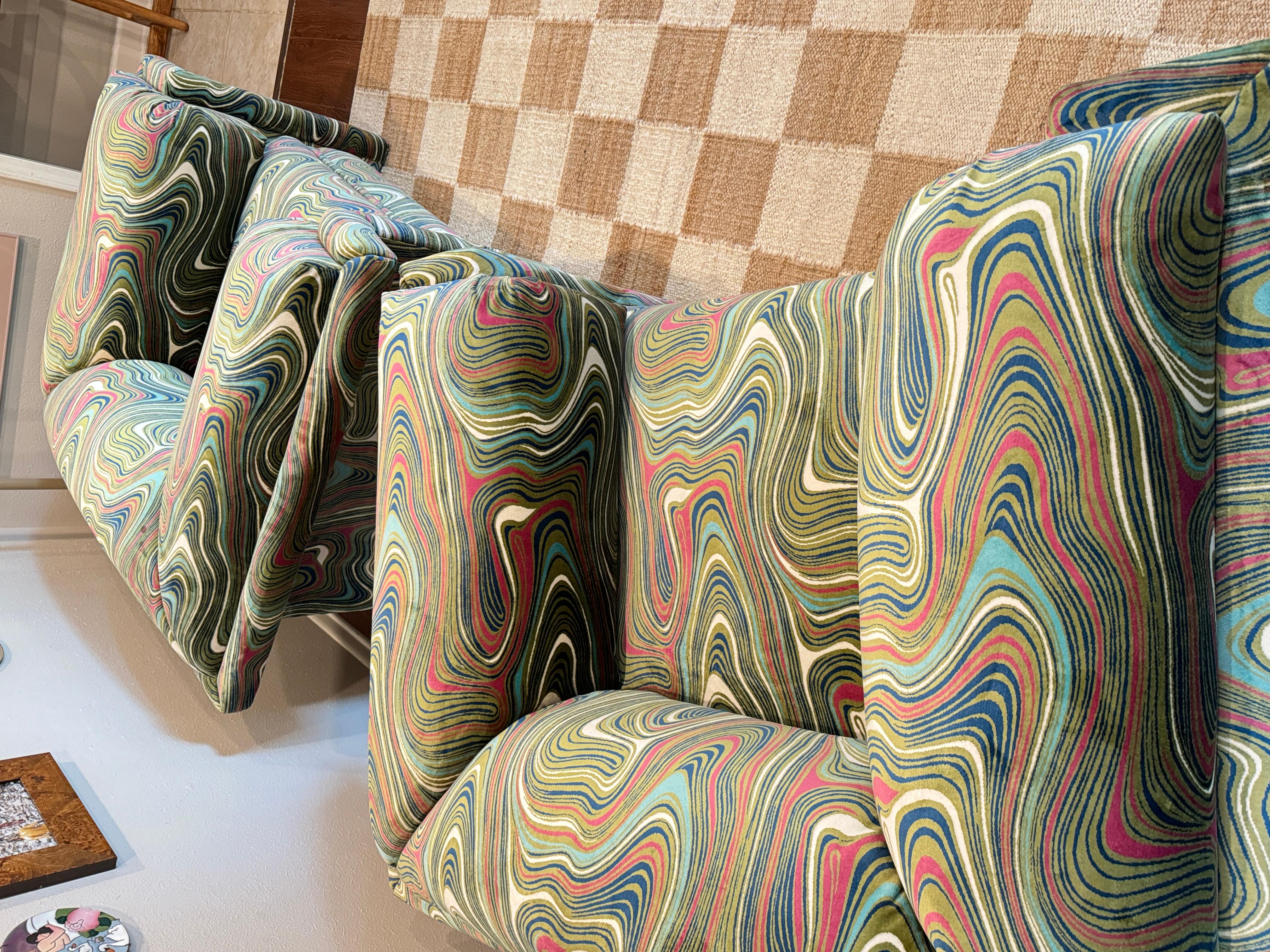 A set of 2 mid century modern lounge chairs with a gold plinth base ...