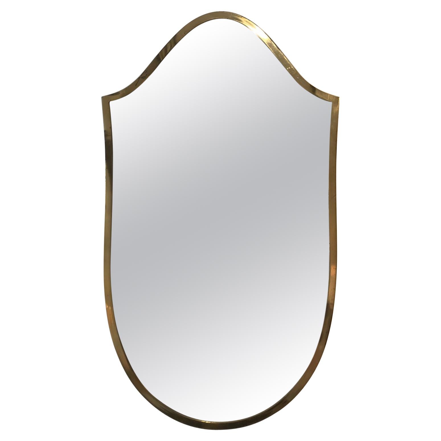 A small Italian 1950s brass shield shaped mirror at 1stDibs
