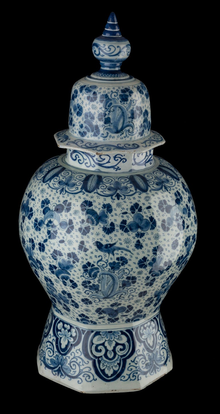 A very large three piece garniture with floral decor. Marked. Delft ...