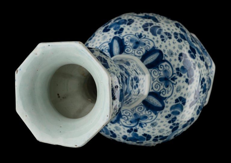 A very large three piece garniture with floral decor. Marked. Delft ...