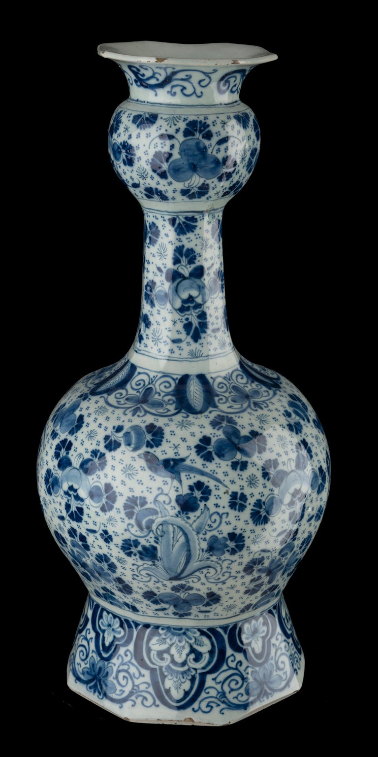 A very large three piece garniture with floral decor. Marked. Delft ...