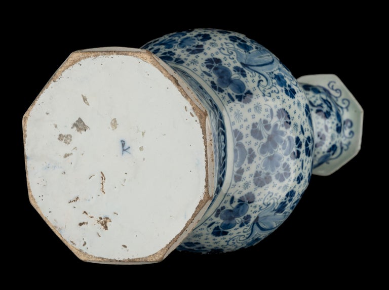 A very large three piece garniture with floral decor. Marked. Delft ...