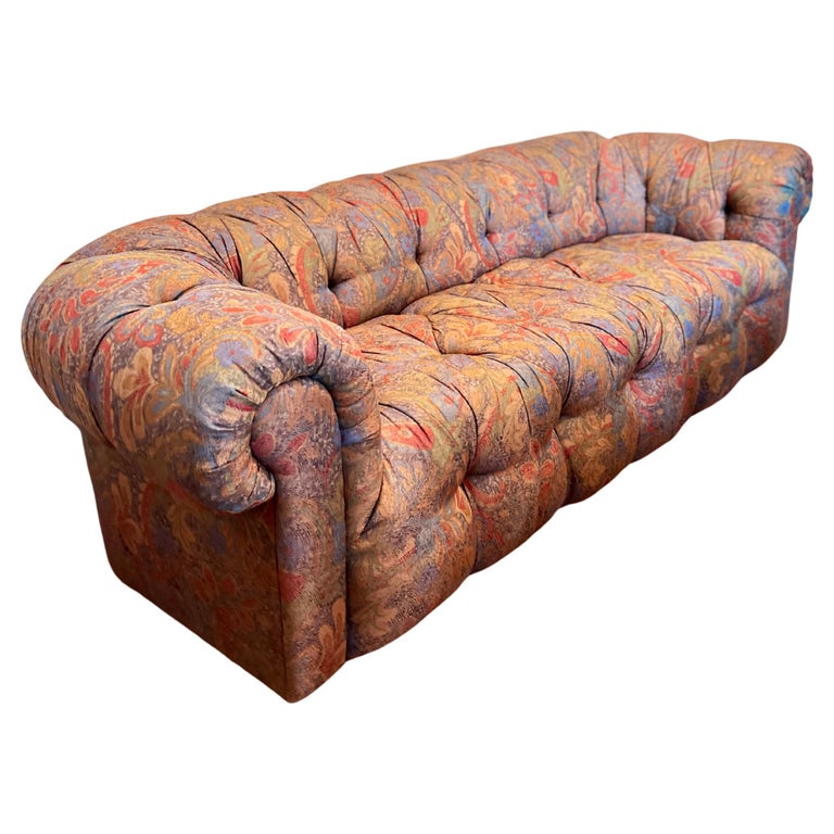 A vintage tufted chesterfield sofa with original jewel tone paisley ...