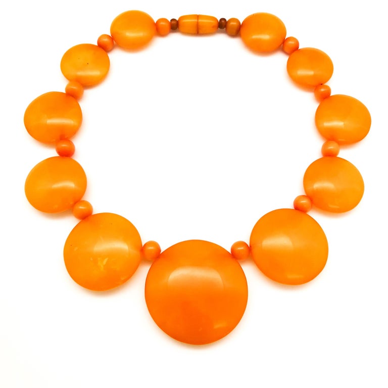 A wonderful orange Bakelite necklace, bangle and ring combination ...