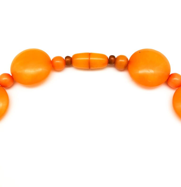 A wonderful orange Bakelite necklace, bangle and ring combination ...