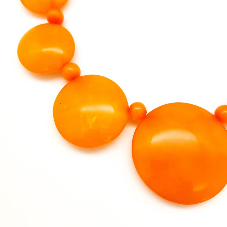 A wonderful orange Bakelite necklace, bangle and ring combination ...