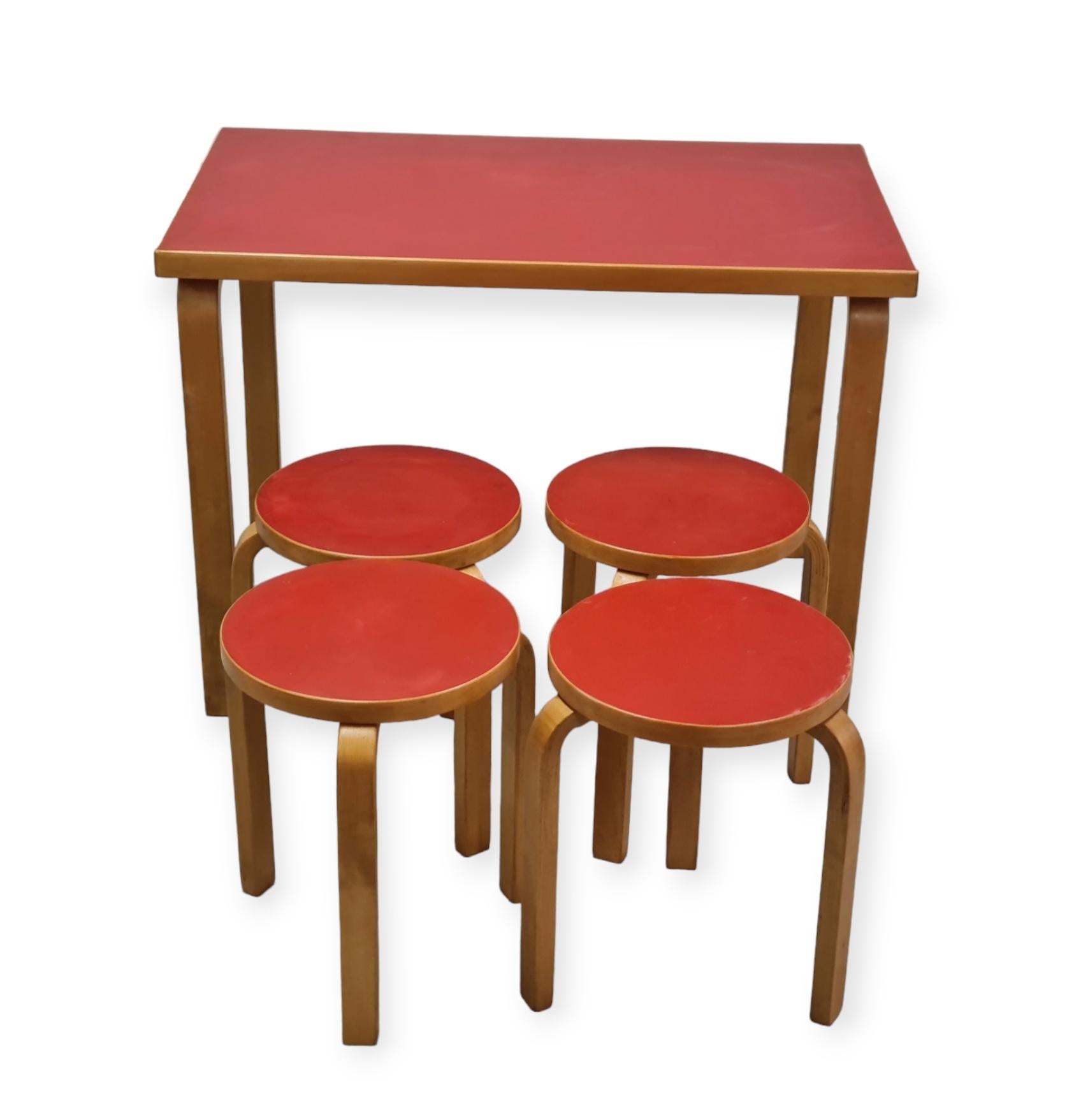 Alvar Aalto Table and 4 Stools in red Linoleum surface. For Sale at 1stDibs