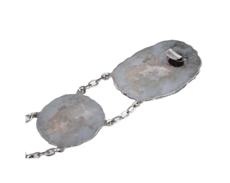 An antique Japanese Meiji period repousse silver belt consisting of ...