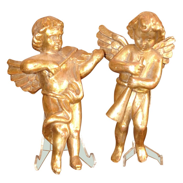 Two Italian carved and later gilded putti For Sale at 1stDibs