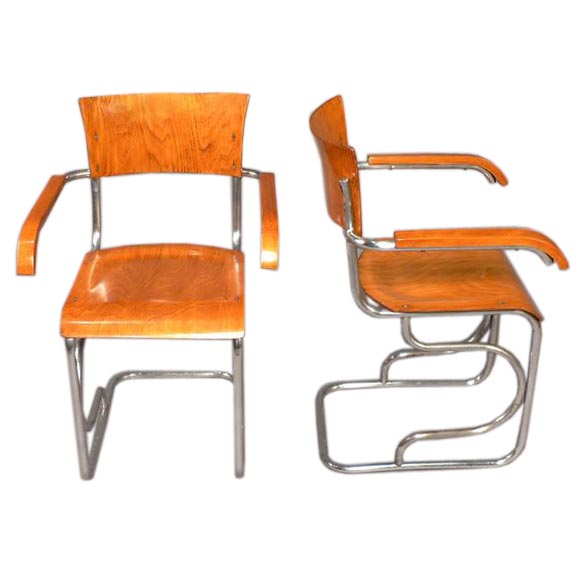 Pair of tubular metal arm chairs at 1stDibs