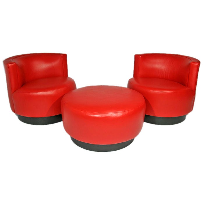 Pair of red leather swivel chairs with ottoman at 1stDibs