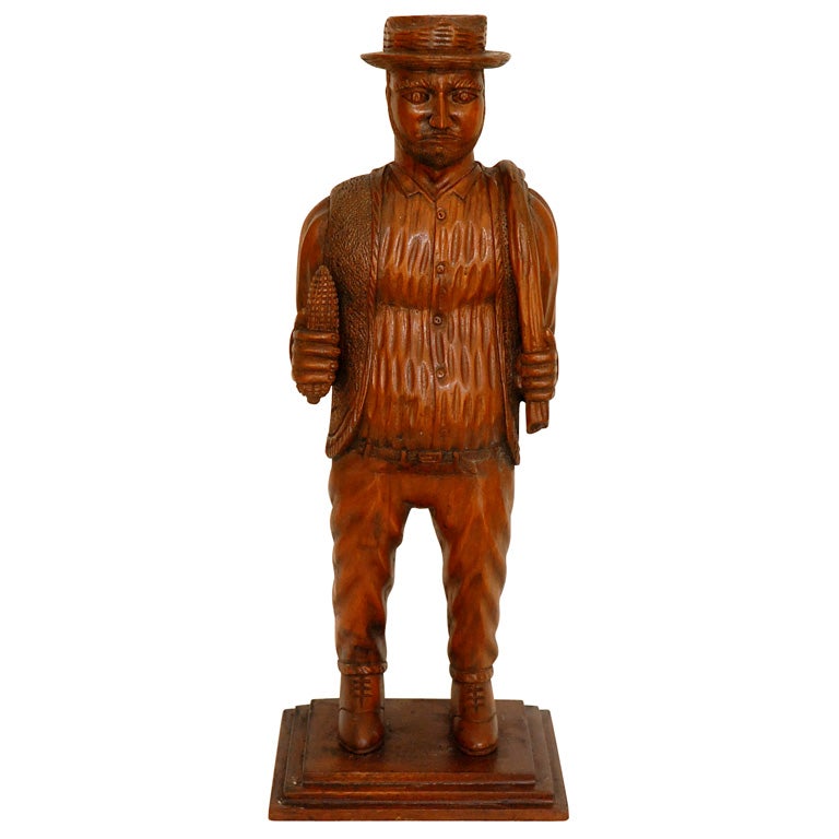 HAND CARVED FOLK ART MAN HOLDING A CORN COB AND A BAG at 1stDibs