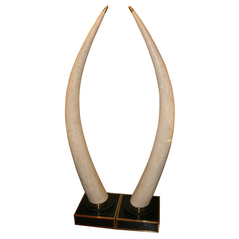 Pair of stone veneer tusks with brass details at 1stDibs