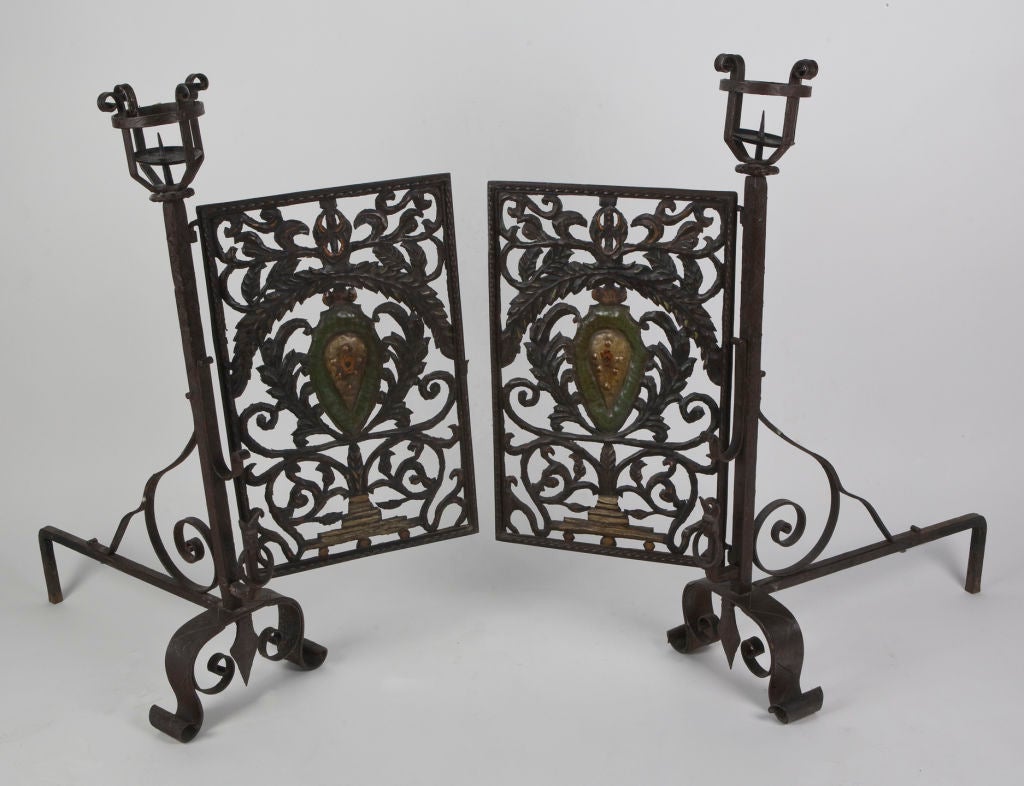 A pair of wrought iron and paint-decorated andirons at 1stDibs