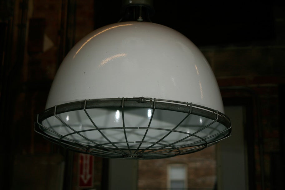 American industrial light fixture with cage. at 1stDibs