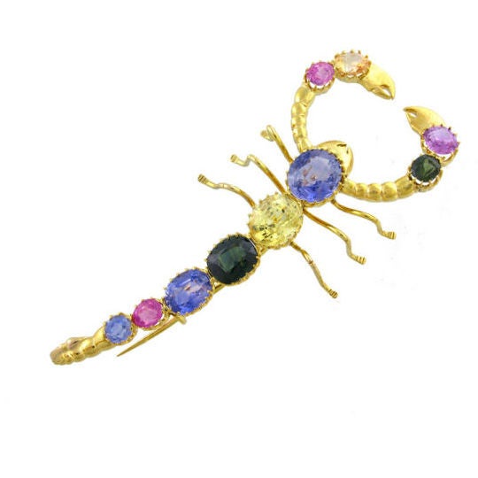 A gold scorpion brooch with multicolor natural sapphires at 1stDibs
