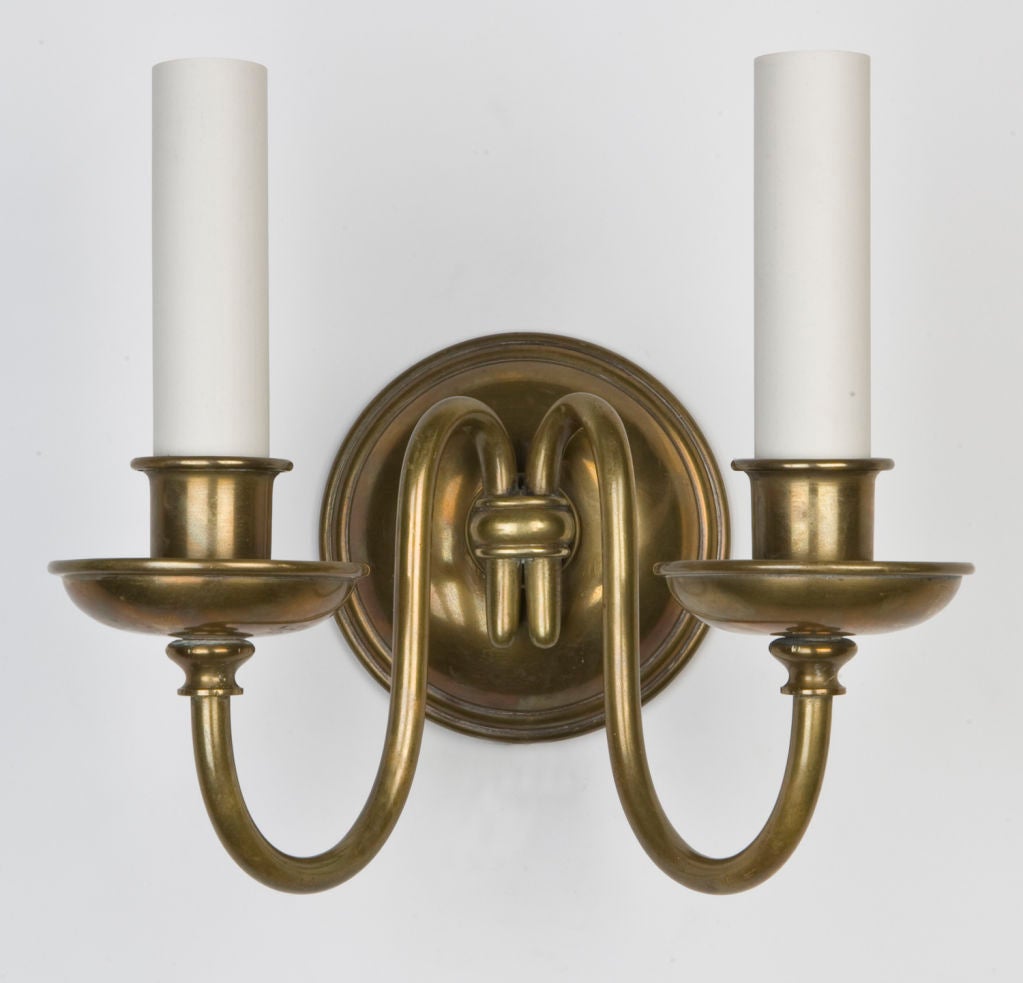 A pair of antique brass double-light round sconces at 1stDibs