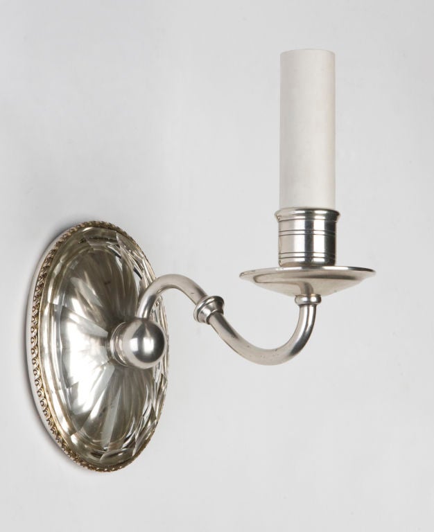 A pair of single light sconces with crystal backplate at 1stDibs