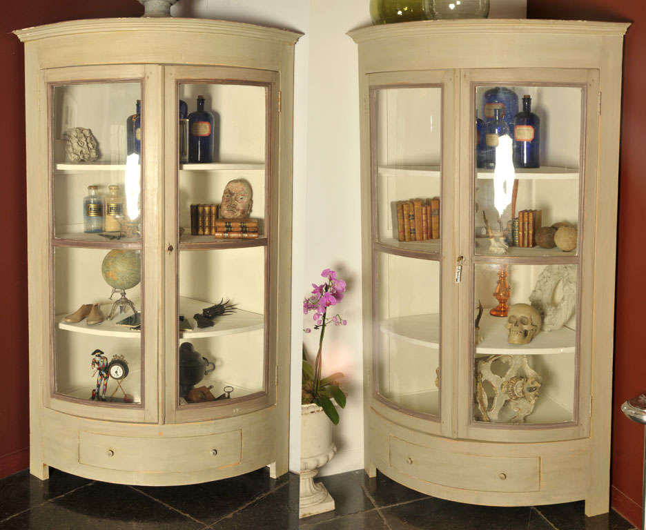 A pair of half round shaped corner cupboards at 1stDibs